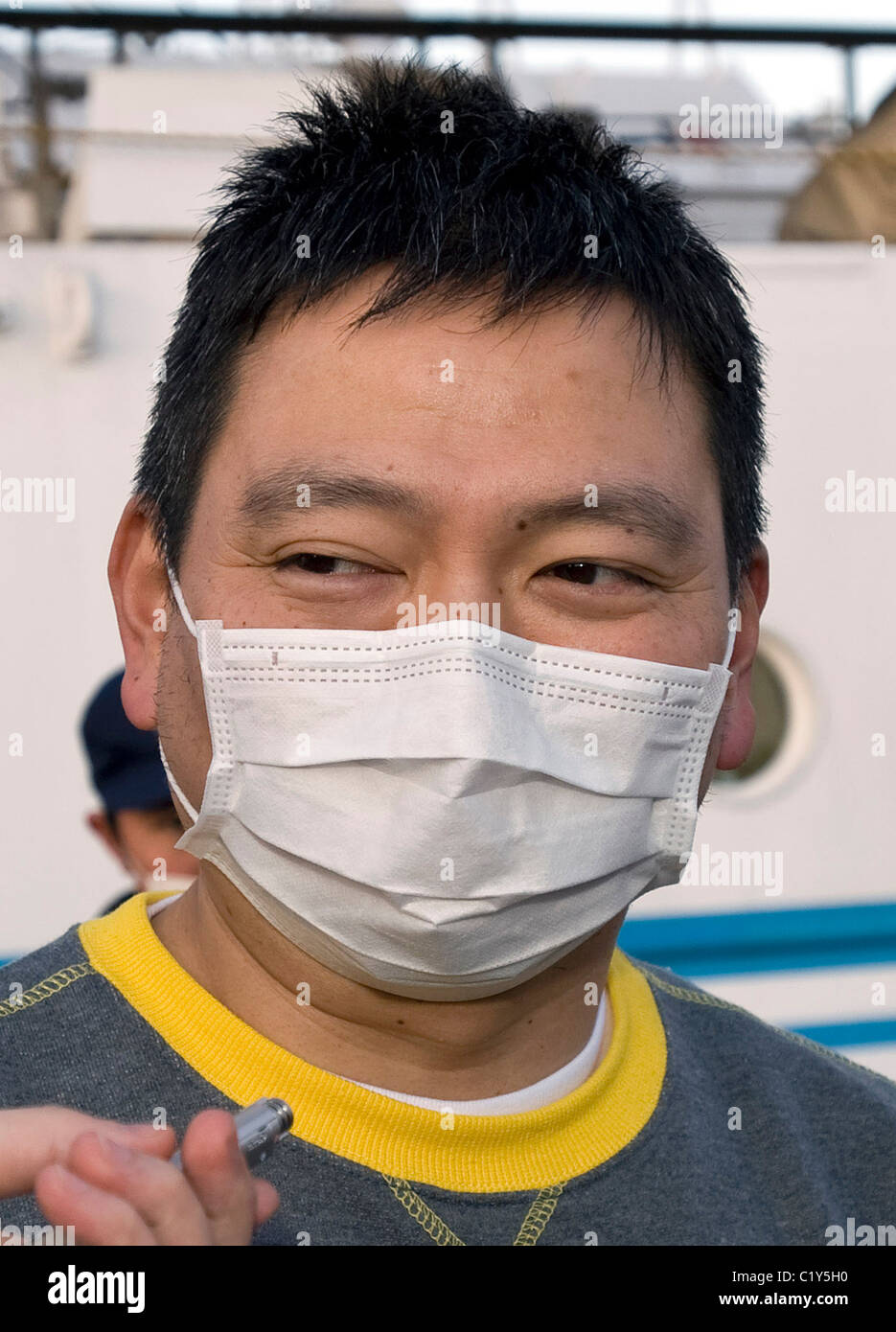 A member of the so-called Fukushima 50 is given a radiation check prior ...