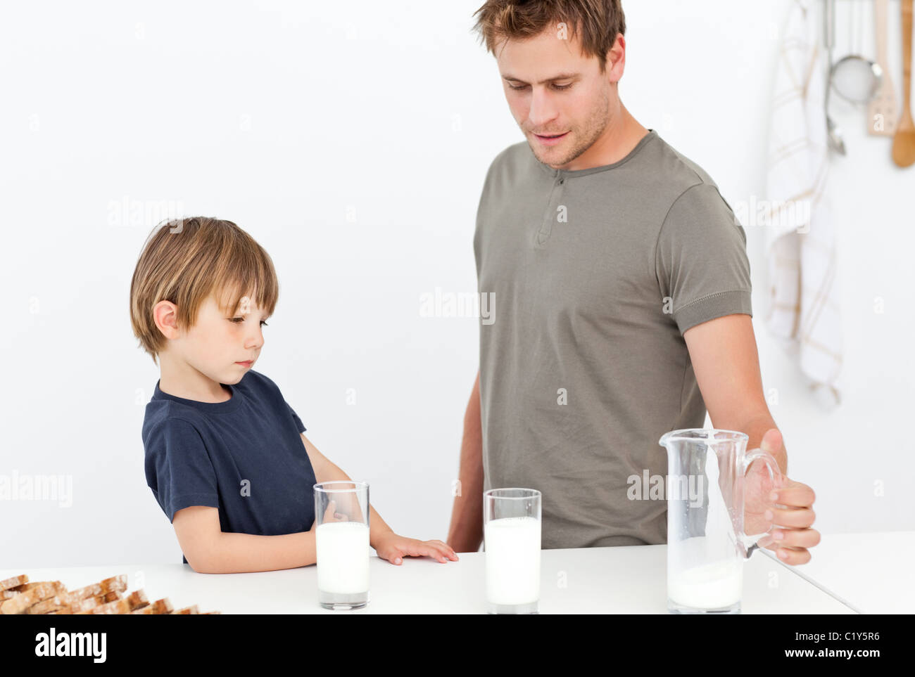 Cute dad and son drinking milk together Stock Photo - Alamy
