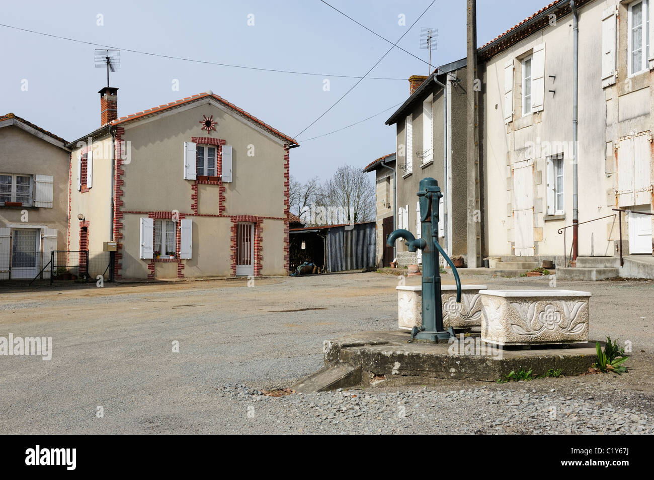 Stock photo of an empty rural French Village Square with a Water pump ...