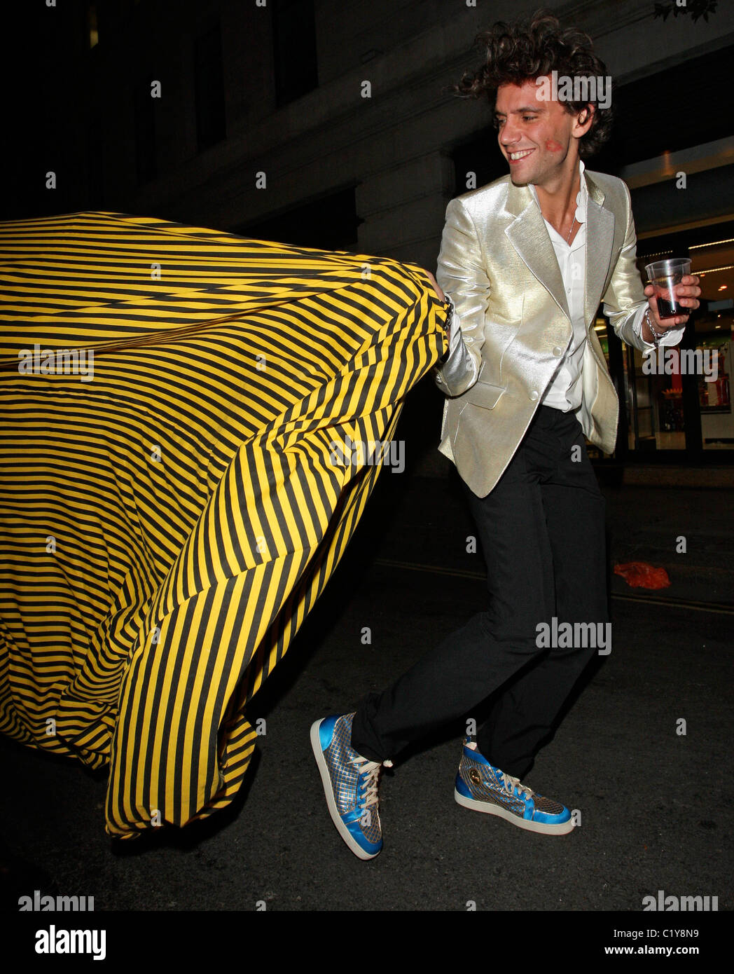 Singer Mika fools around with friends as he arrives at the Mayfair ...