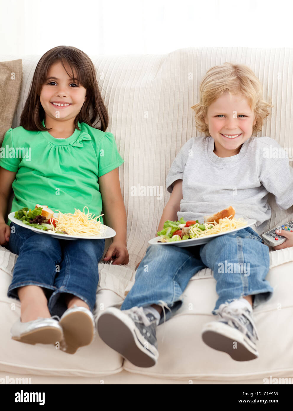 Child watching tv eating dinner hi-res stock photography and images - Alamy