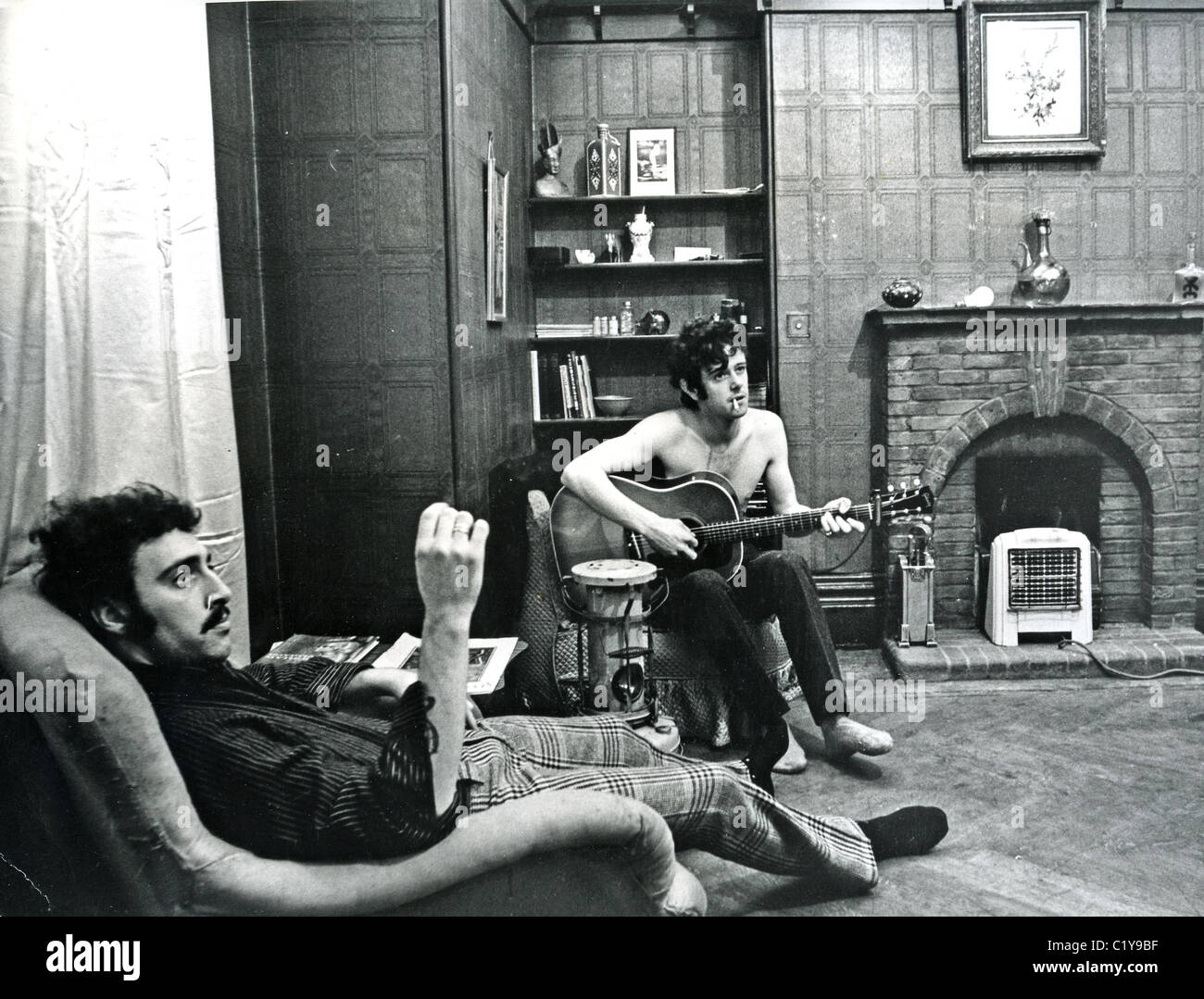 DONOVAN on guitar next to a parafin stove with Gypsy Dave (left) at ...