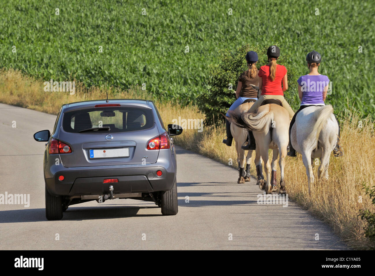 car overtaking riders Stock Photo - Alamy