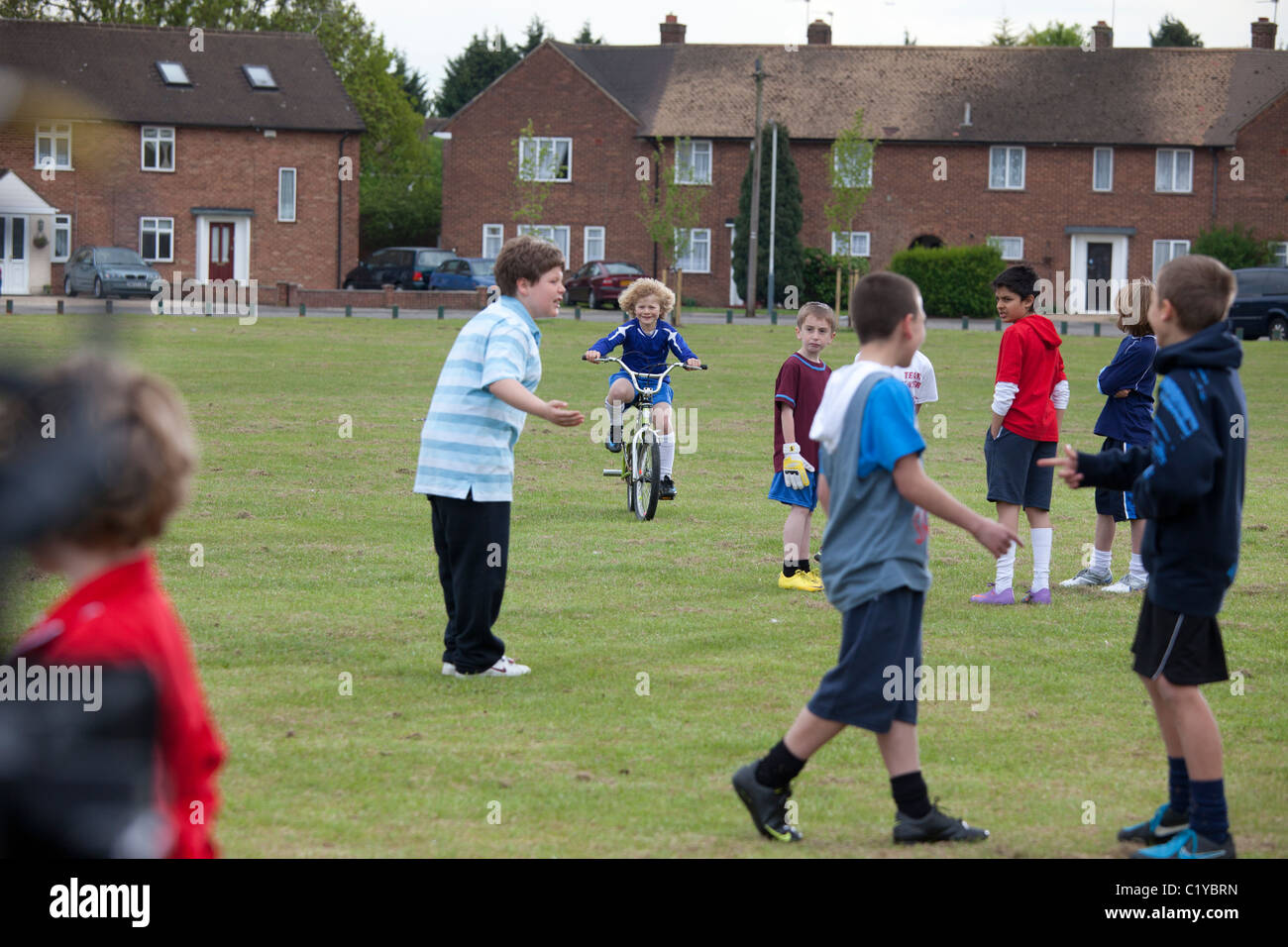 kids children boys playing "council estate" green Stock Photo - Alamy