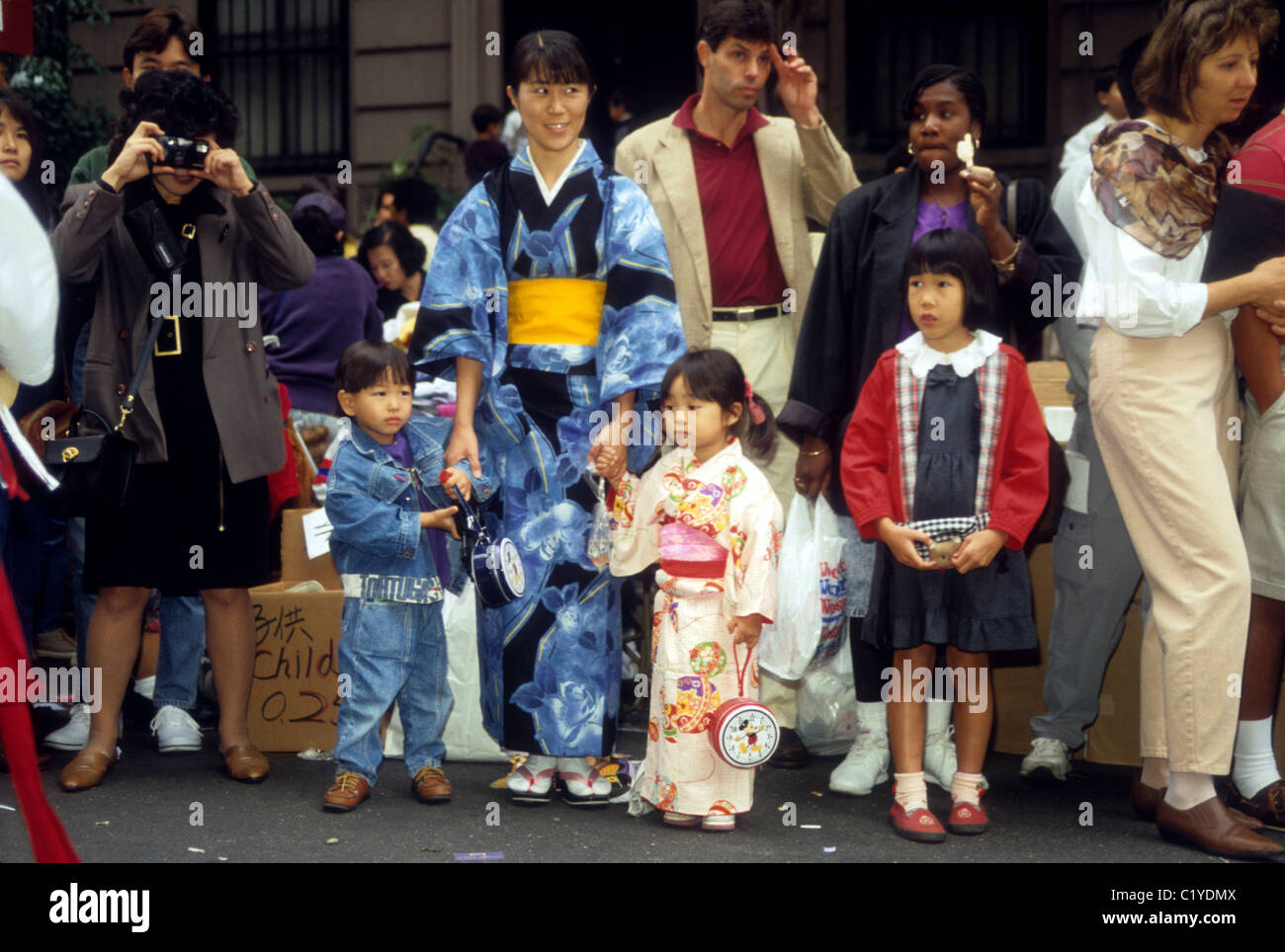 A Japanese-American mother and her children watch a performance at an ...