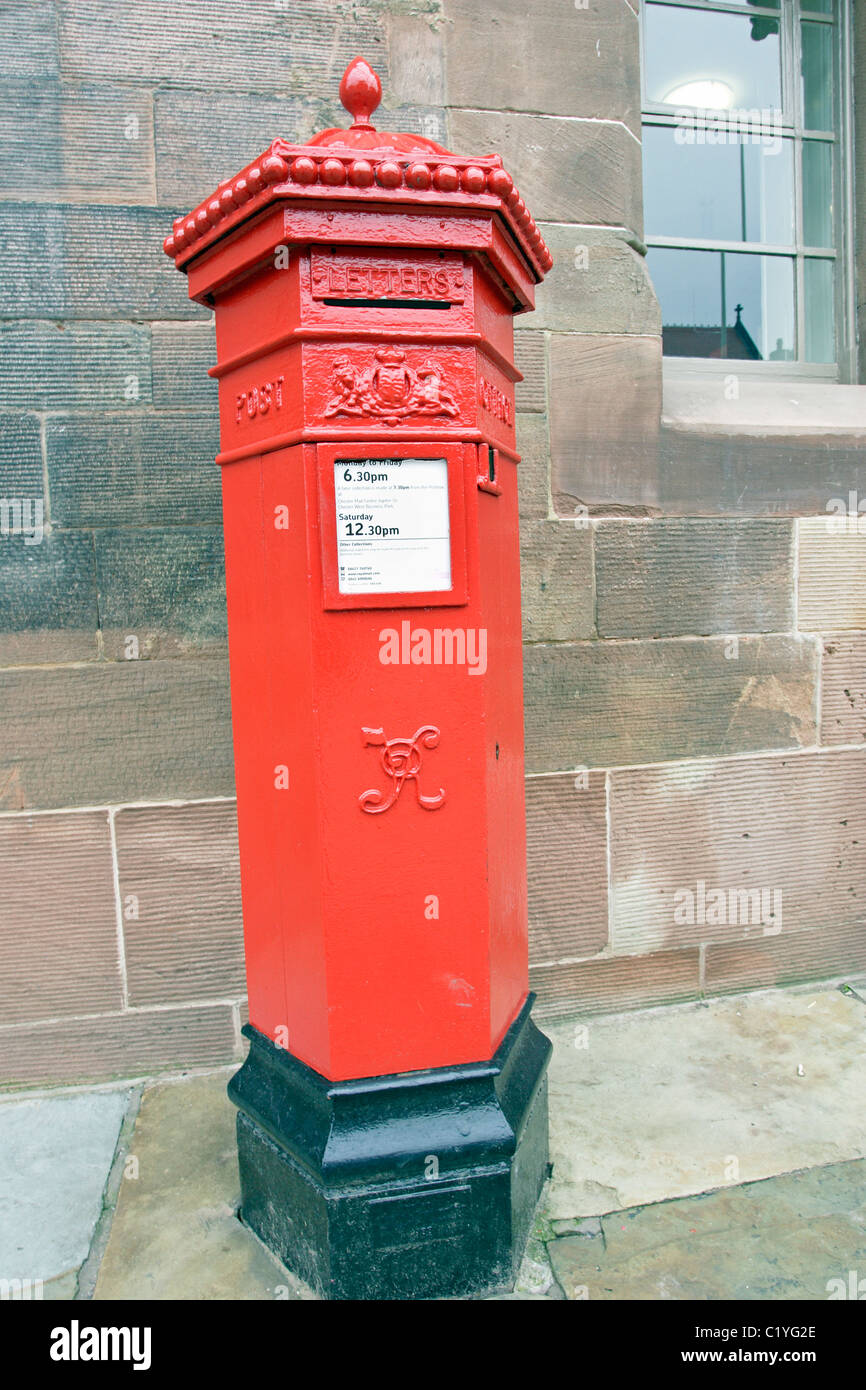 A red Victorian postbox outside the town hall in the historic city of ...