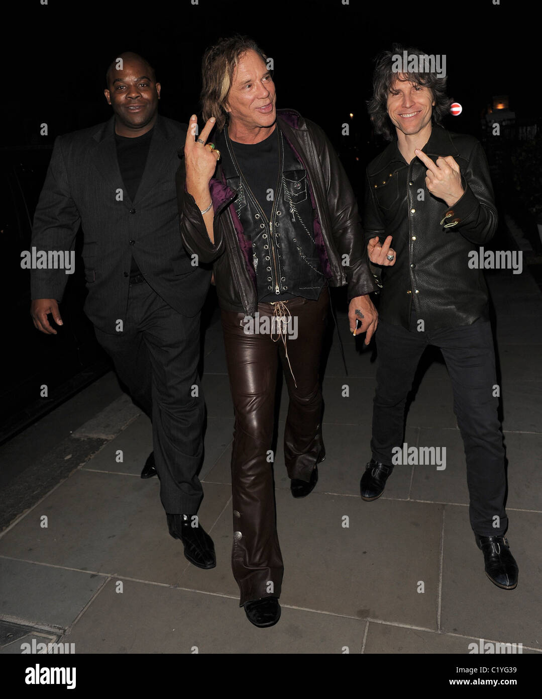 Mickey Rourke arrives back at his hotel with his minder and a male ...