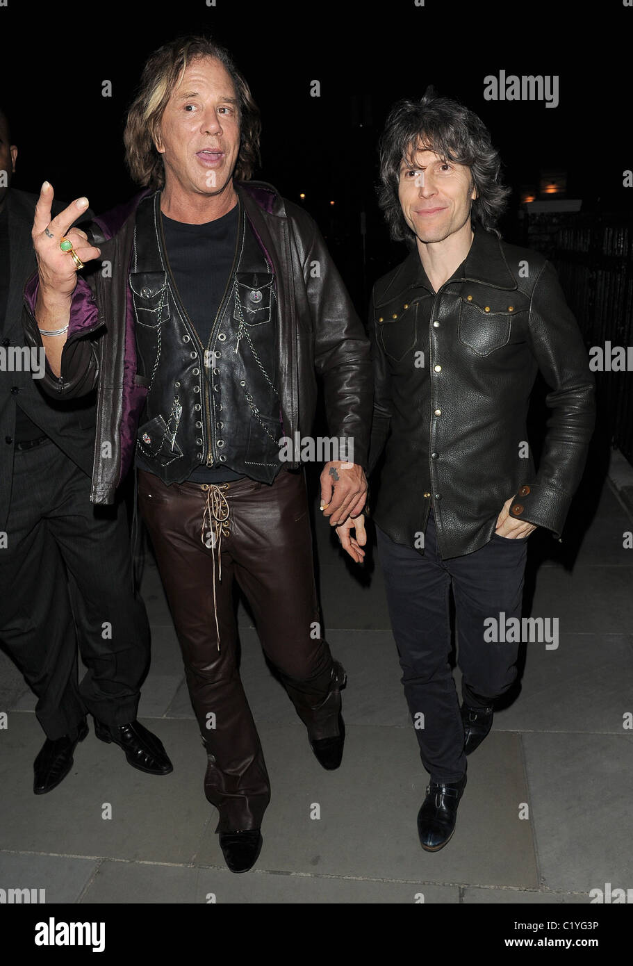 Mickey Rourke arrives back at his hotel with his minder and a male ...