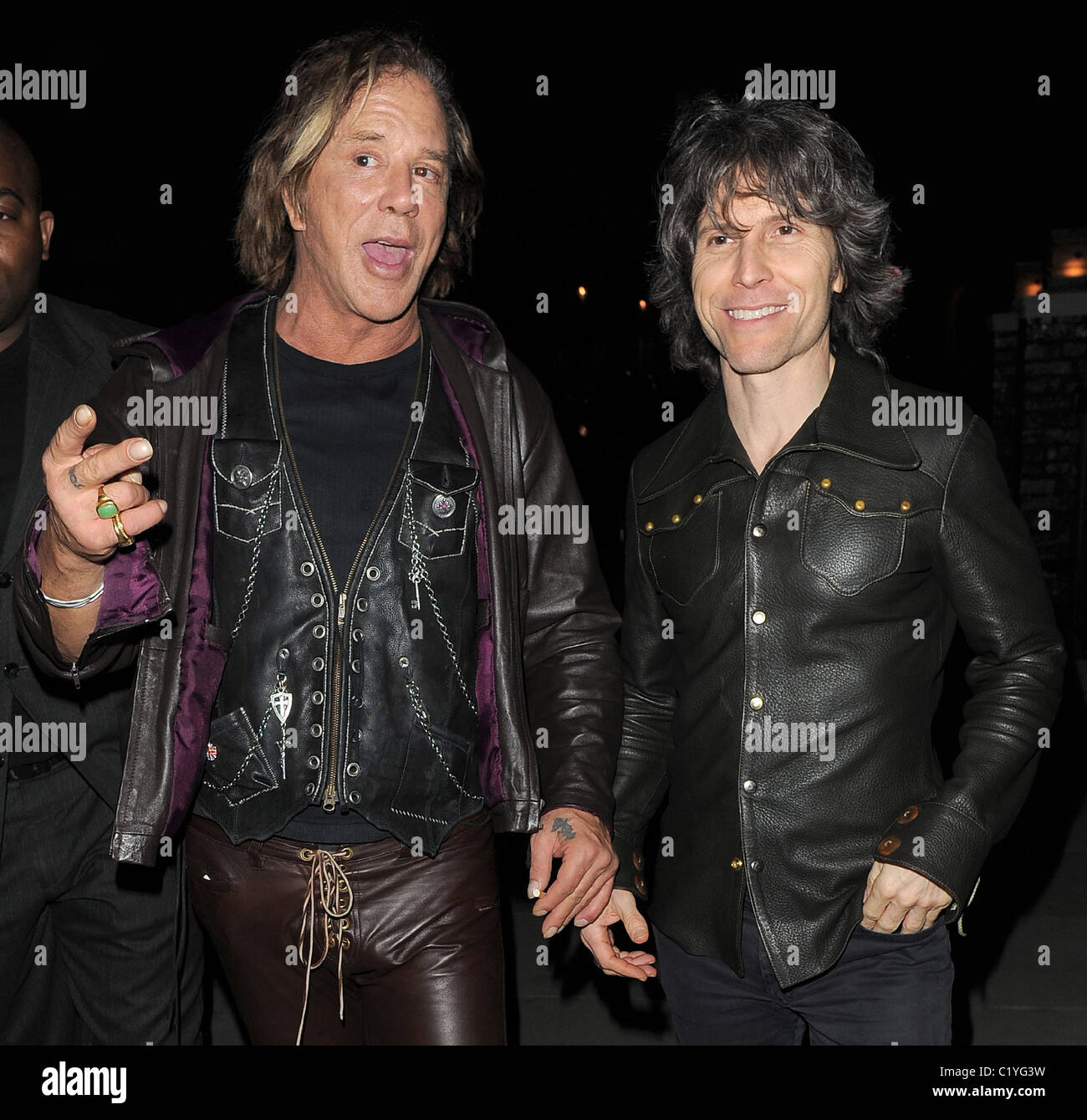 Mickey Rourke arrives back at his hotel with his minder and a male ...