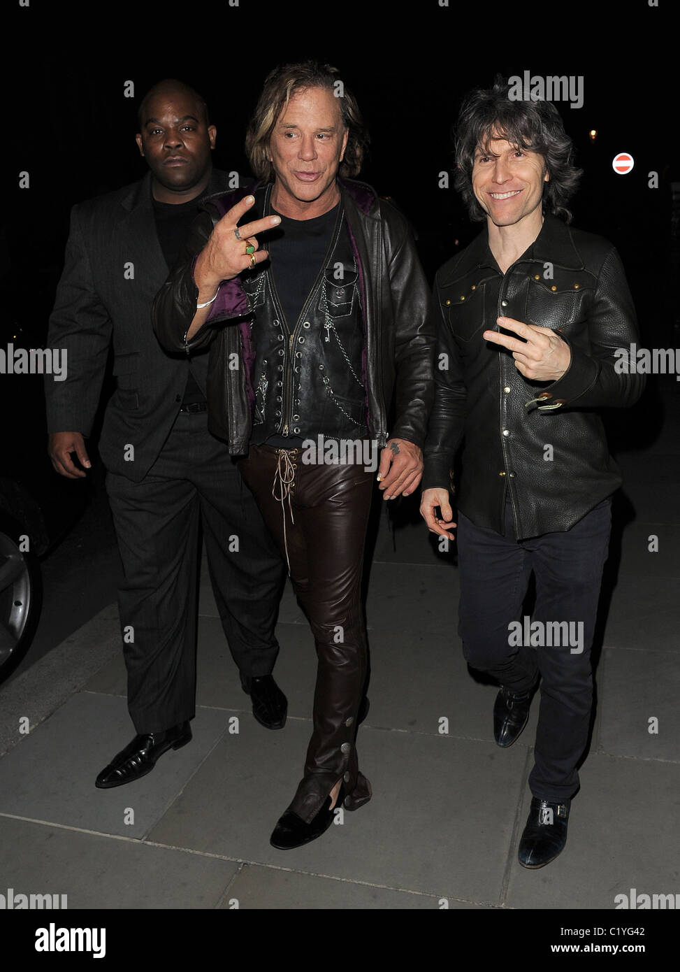 Mickey Rourke arrives back at his hotel with his minder and a male ...