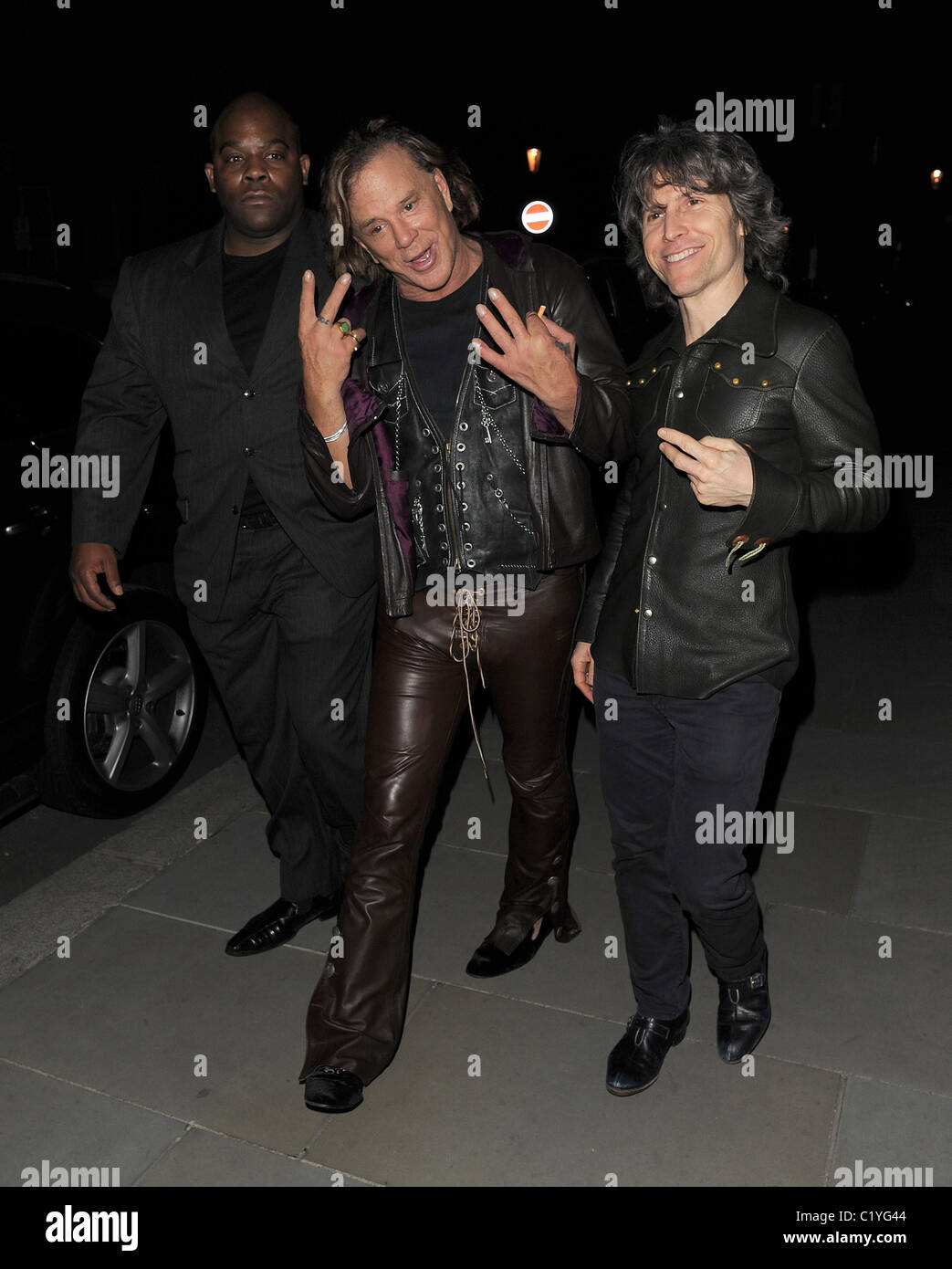 Mickey Rourke arrives back at his hotel with his minder and a male ...