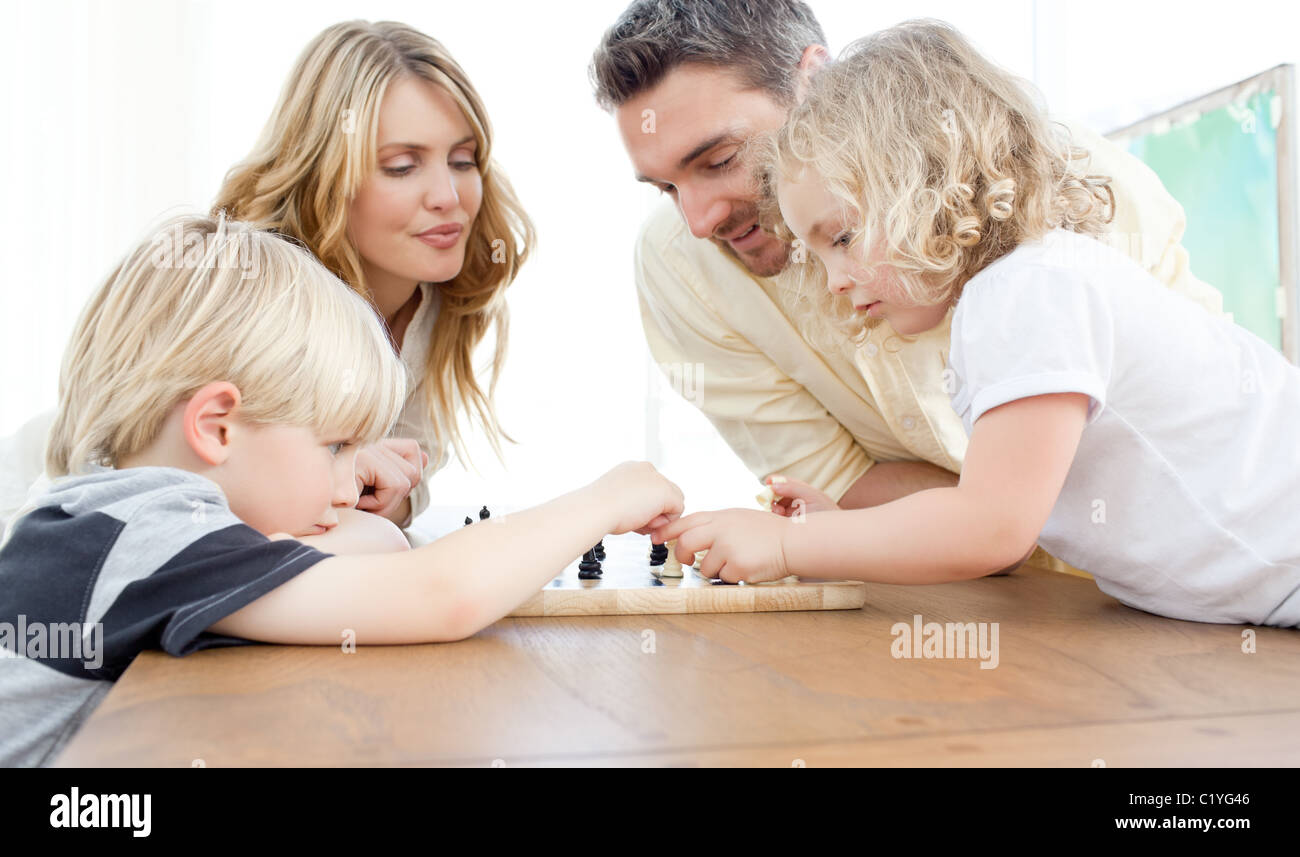 Family playing chess on a table Stock Photo - Alamy