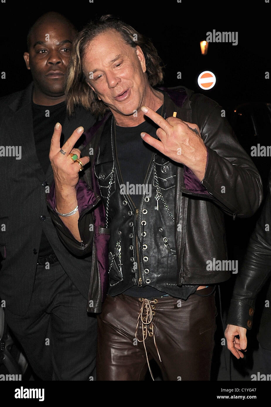 Mickey Rourke arrives back at his hotel with his minder and a male ...