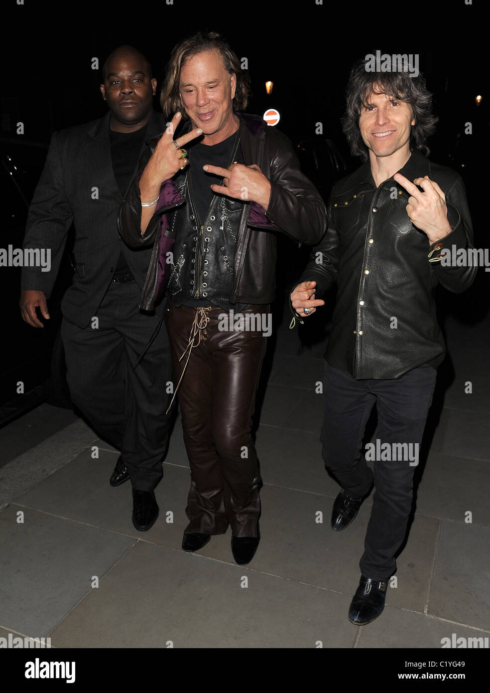 Mickey Rourke arrives back at his hotel with his minder and a male ...