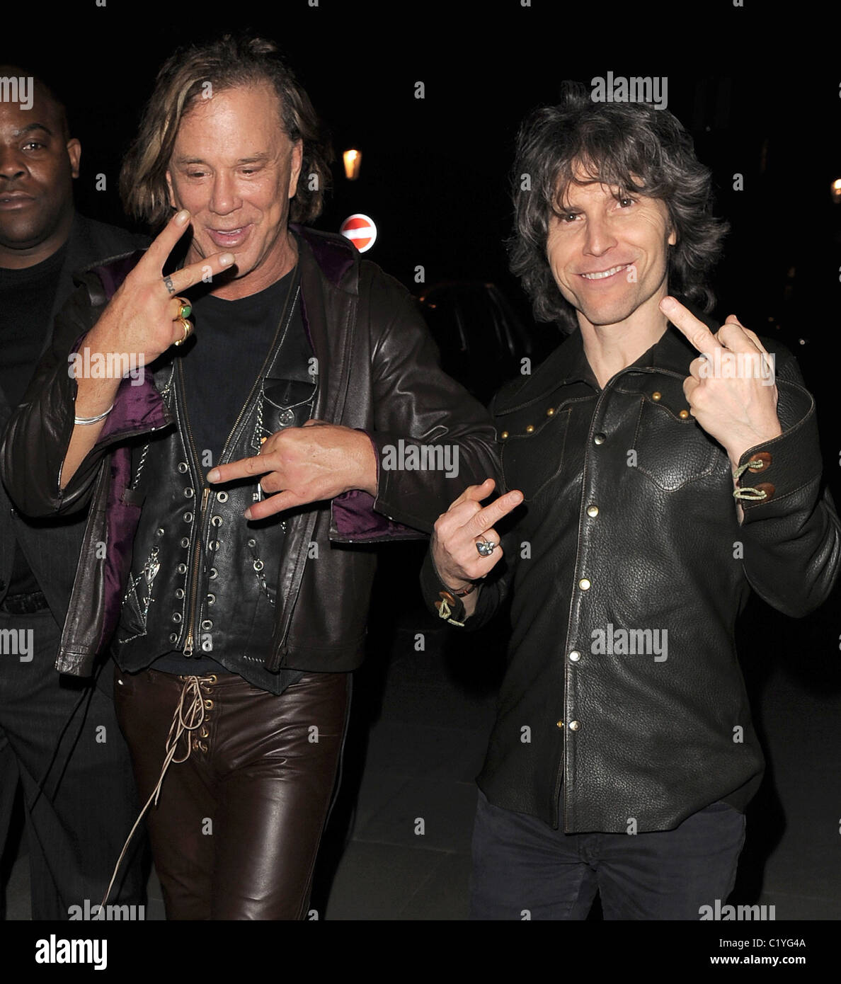 Mickey Rourke arrives back at his hotel with his minder and a male ...