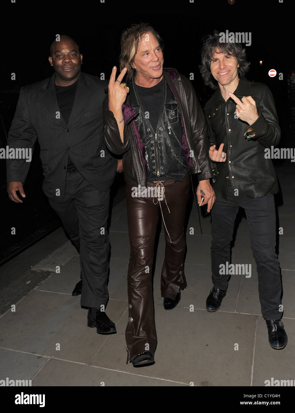 Mickey Rourke arrives back at his hotel with his minder and a male ...
