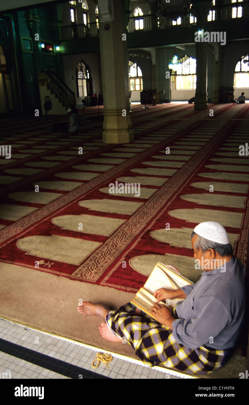 Singapore. Muslim follower reads Koran in Singapore Sultan mosque © Bob ...