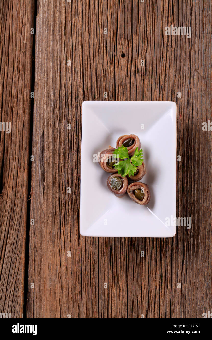 Rolled up anchovy fillets filled with capers Stock Photo - Alamy