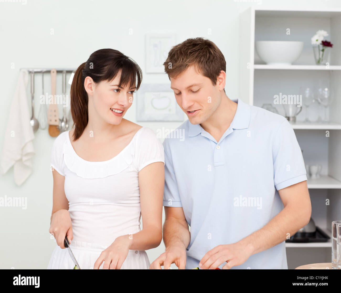 Lovers cooking together in the kitchen Stock Photo - Alamy