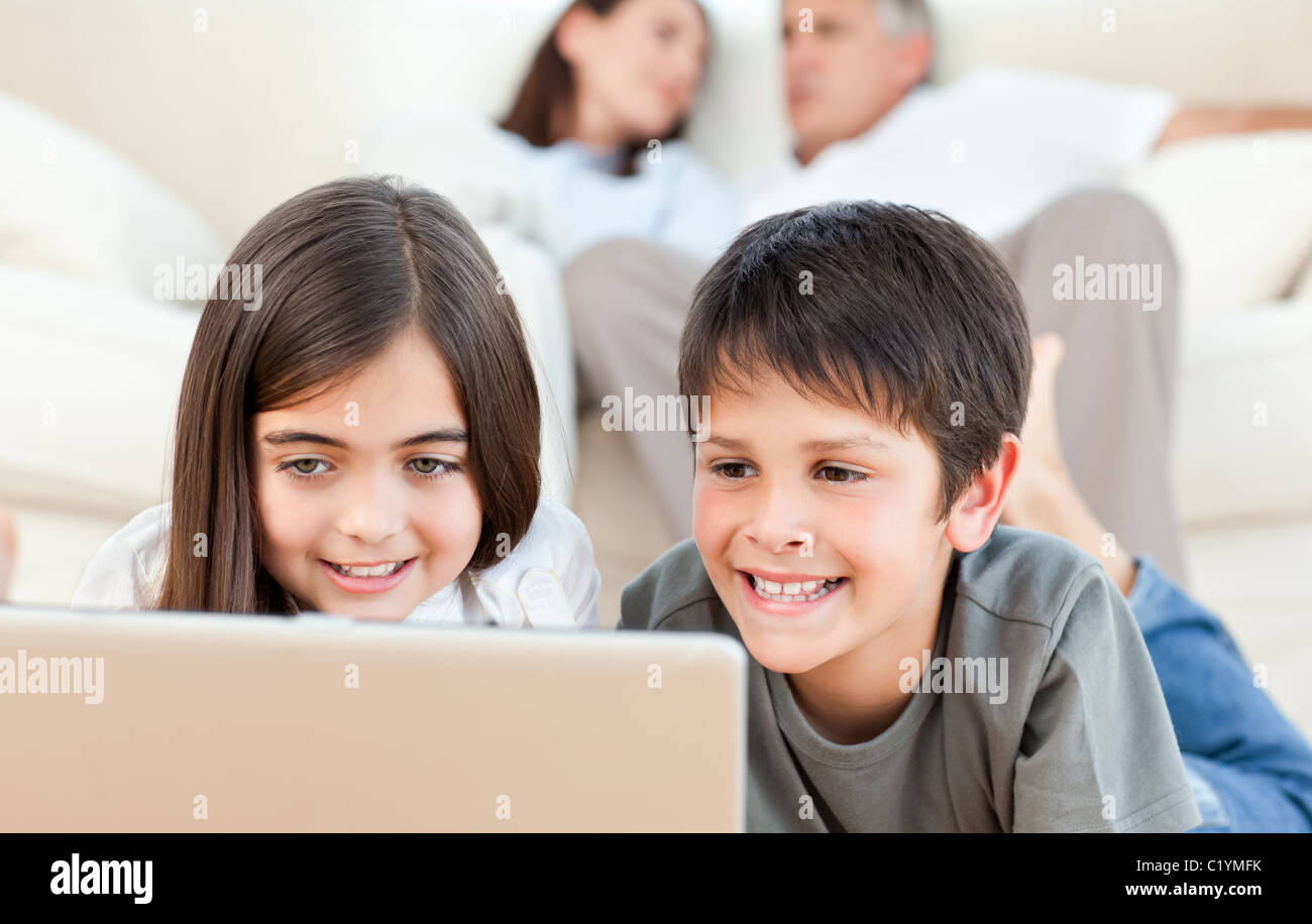 Lovely children watching a movie on their laptop at home Stock Photo ...