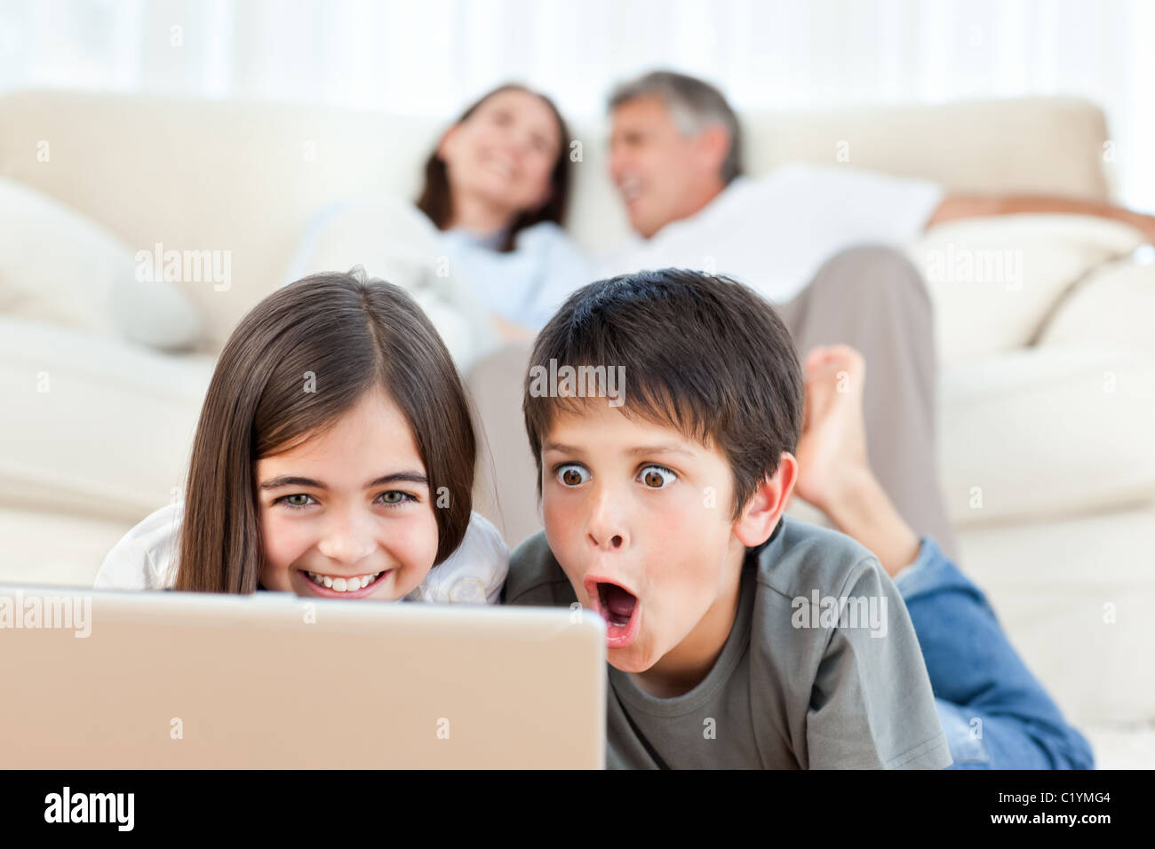 Lovely children watching a movie on their laptop at home Stock Photo ...