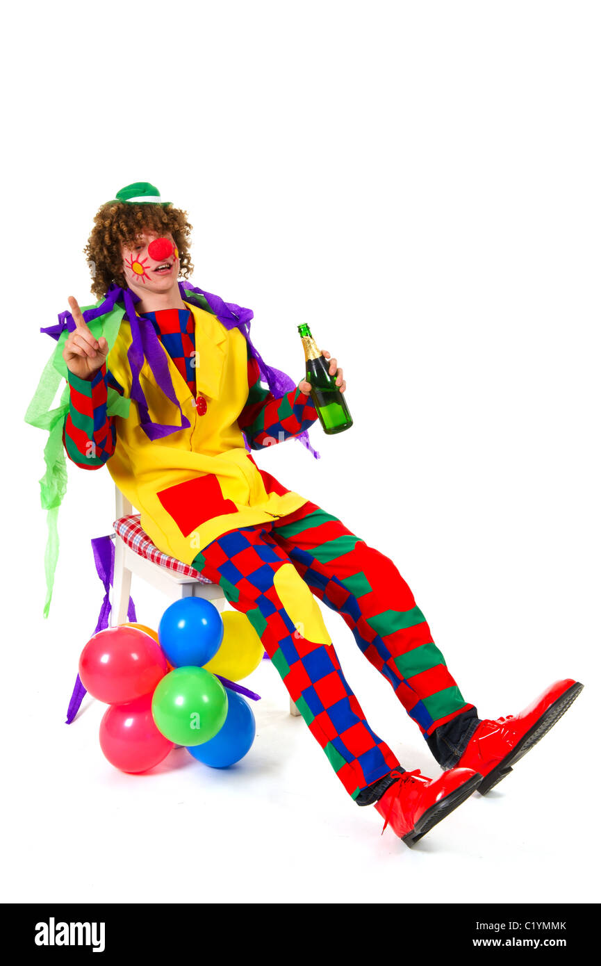 Clown is drinking with a bottle of wine Stock Photo - Alamy