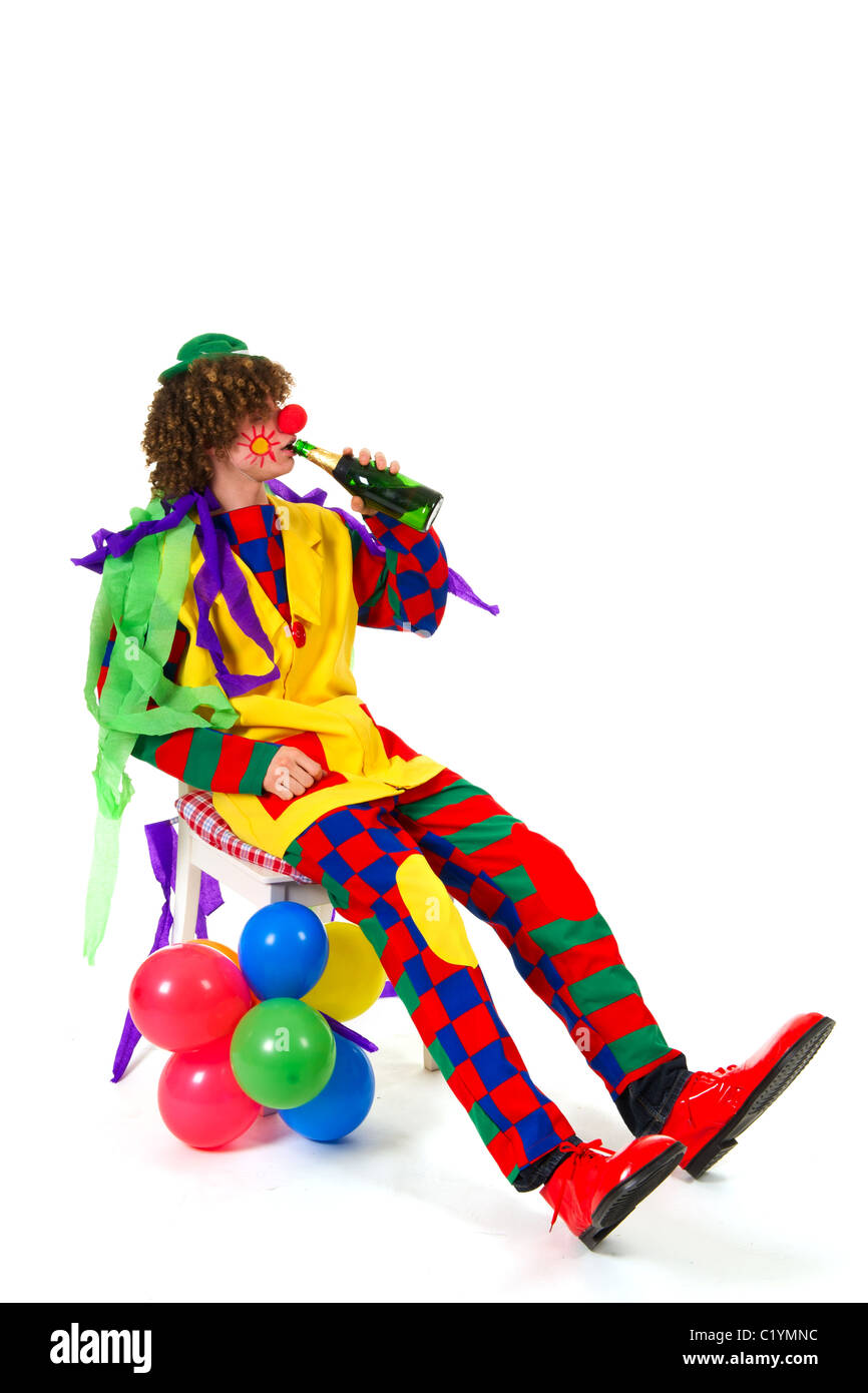 Clown is drinking with a bottle of wine Stock Photo - Alamy