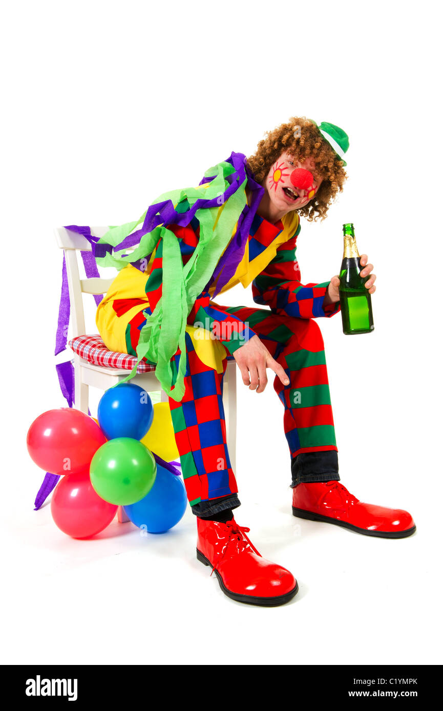 Clown is drinking with a bottle of wine Stock Photo - Alamy
