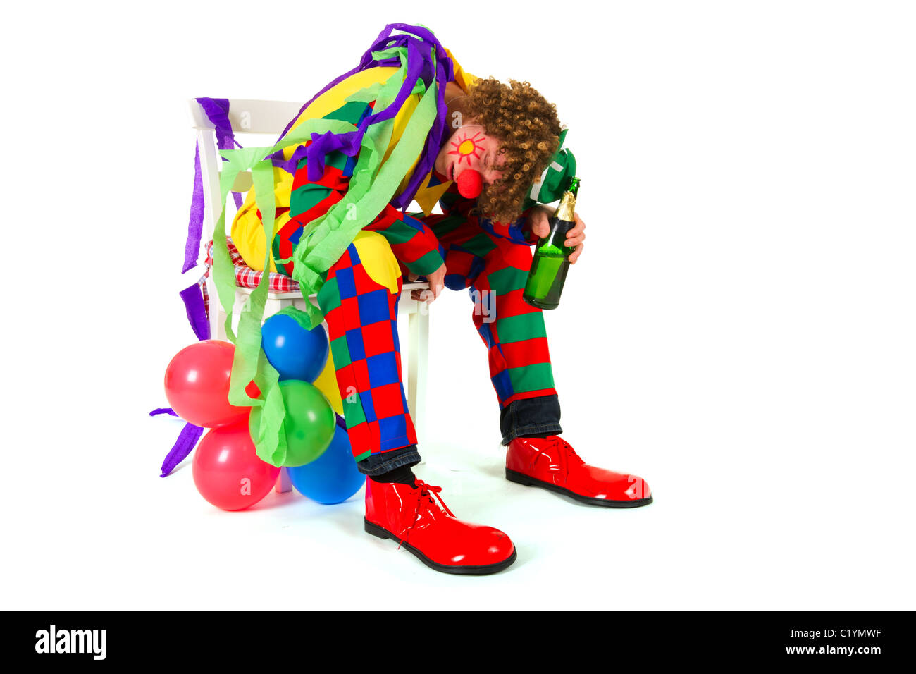 Clown is drinking with a bottle of wine Stock Photo - Alamy