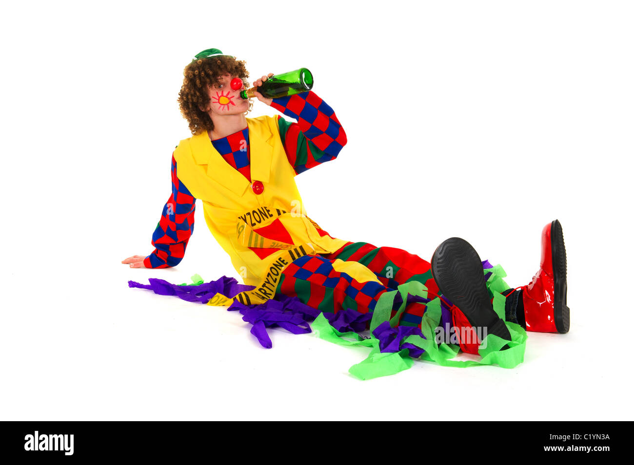 Clown is drinking with a bottle of wine Stock Photo - Alamy
