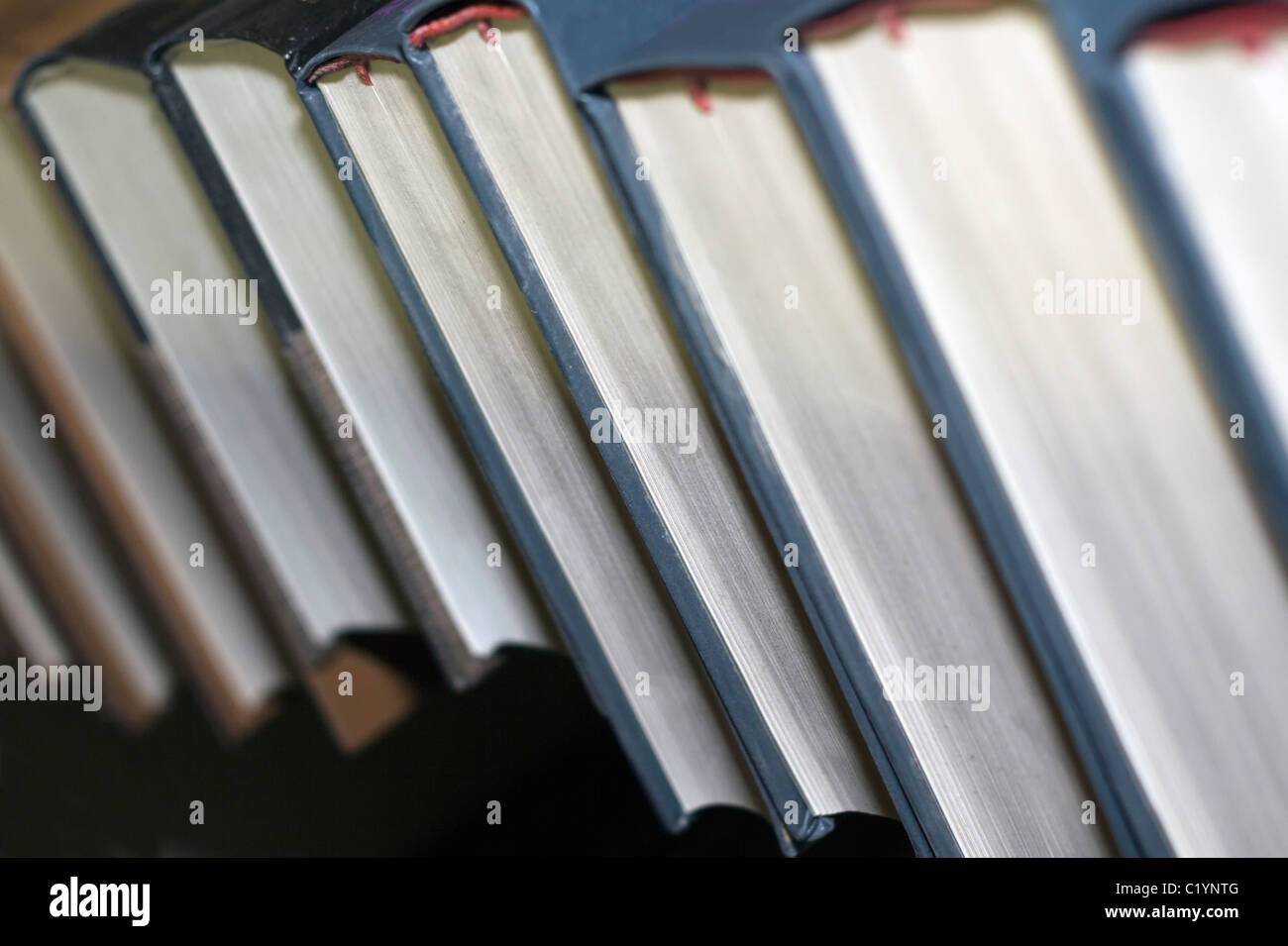 Old books in a row on a bookshelf Stock Photo - Alamy