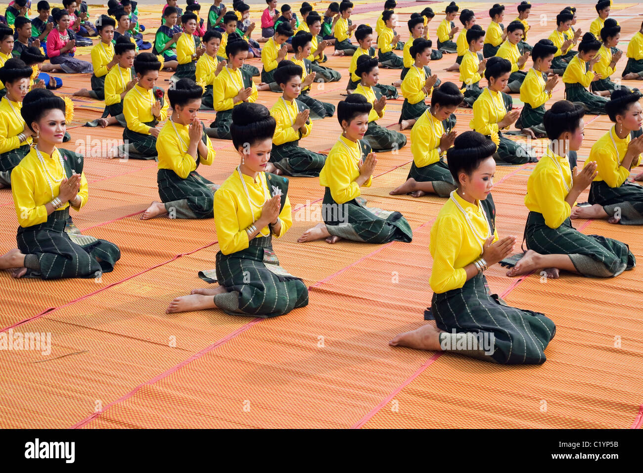 Dancers in traditional Isan dress gather in front of Wat Phra That ...