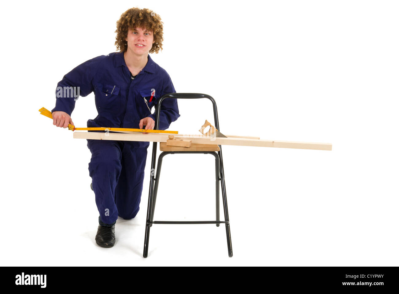 Young boy working as carpenter with timbers and tools Stock Photo - Alamy