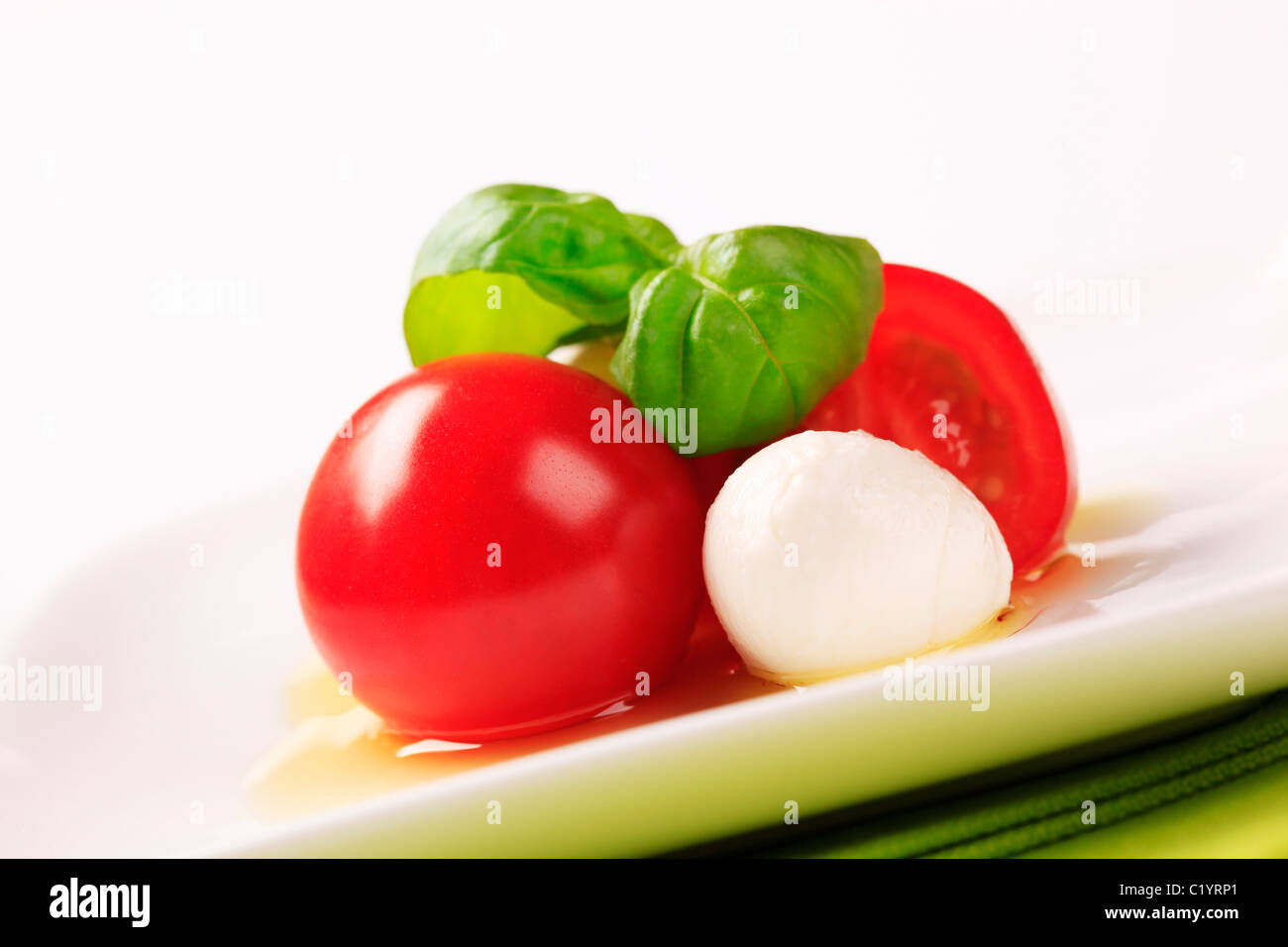 Baby mozzarella cheese balls, tomatoes and basil Stock Photo - Alamy