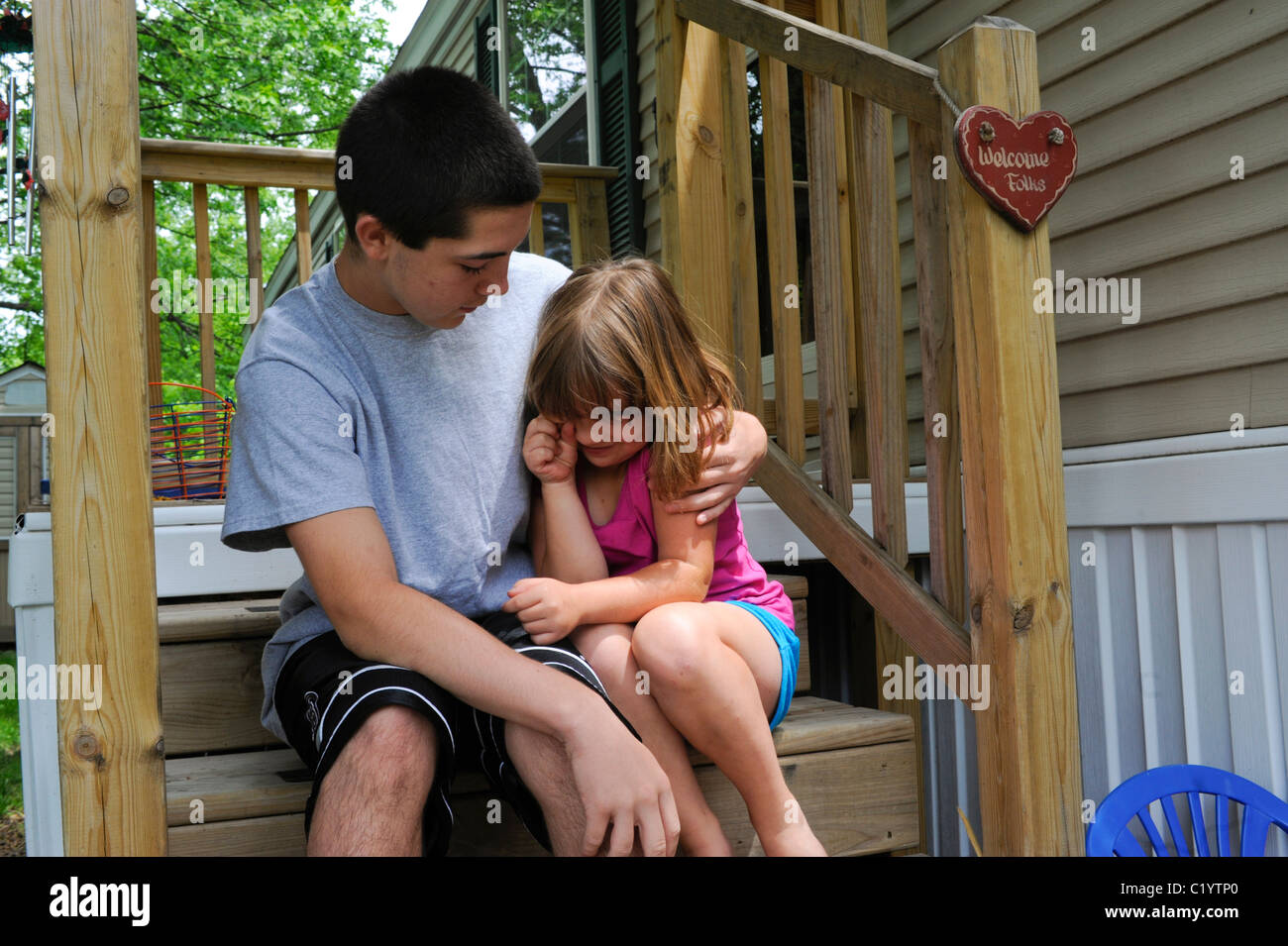 Boy consoling crying sister Stock Photo - Alamy