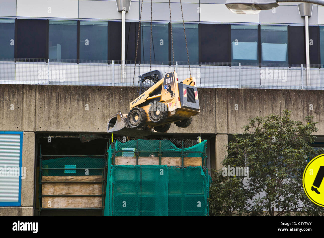 A Mustang digger being lifted Stock Photo - Alamy