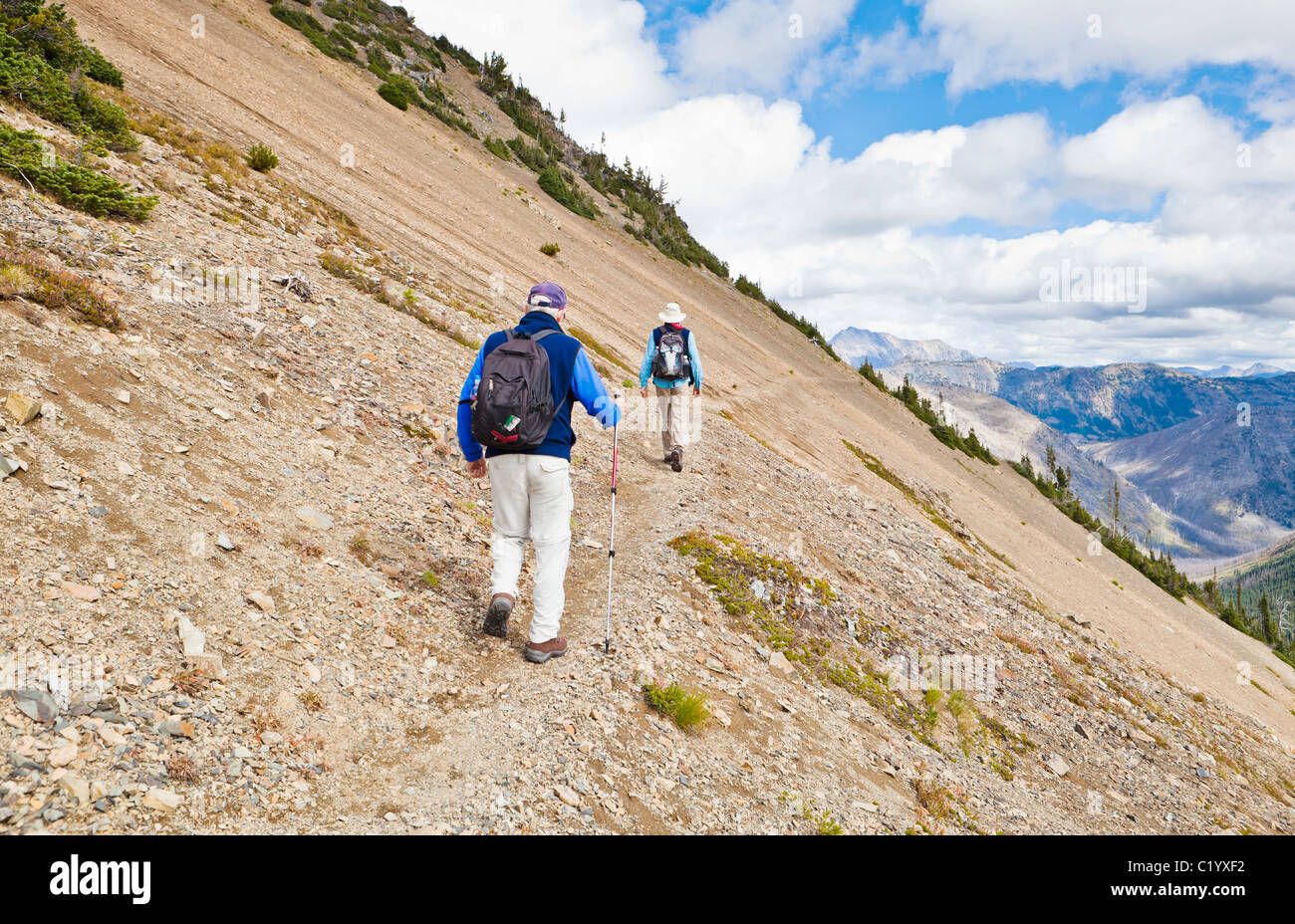 Two men walking along a mountainside on a narrow trail. Pacific Crest ...