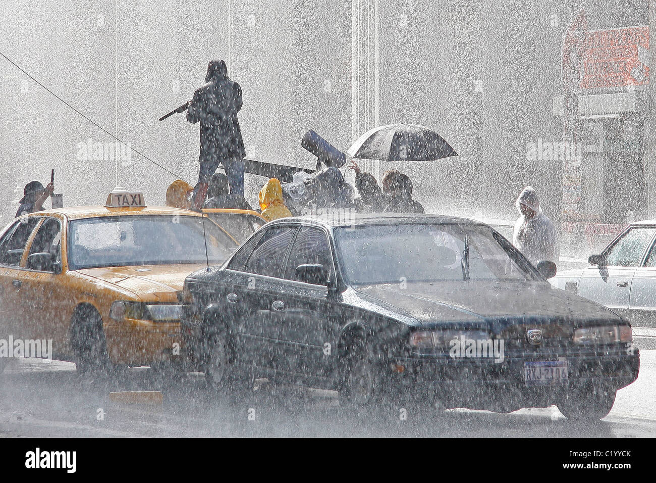 Artificial rain is created for a scene on the film set of the new ...