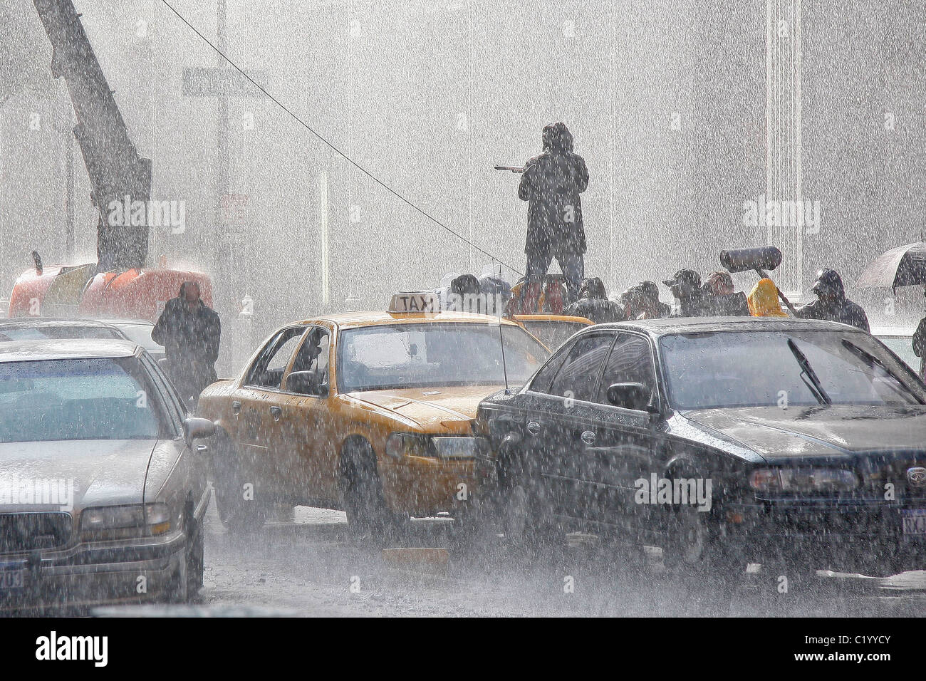 Artificial rain is created for a scene on the film set of the new ...
