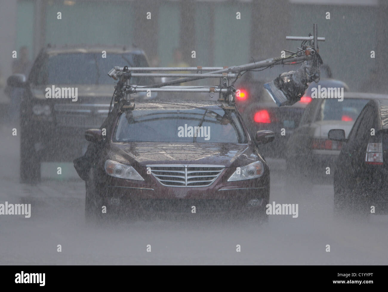 Leonardo DiCaprio driving a car in the rain while filming a scene for ...