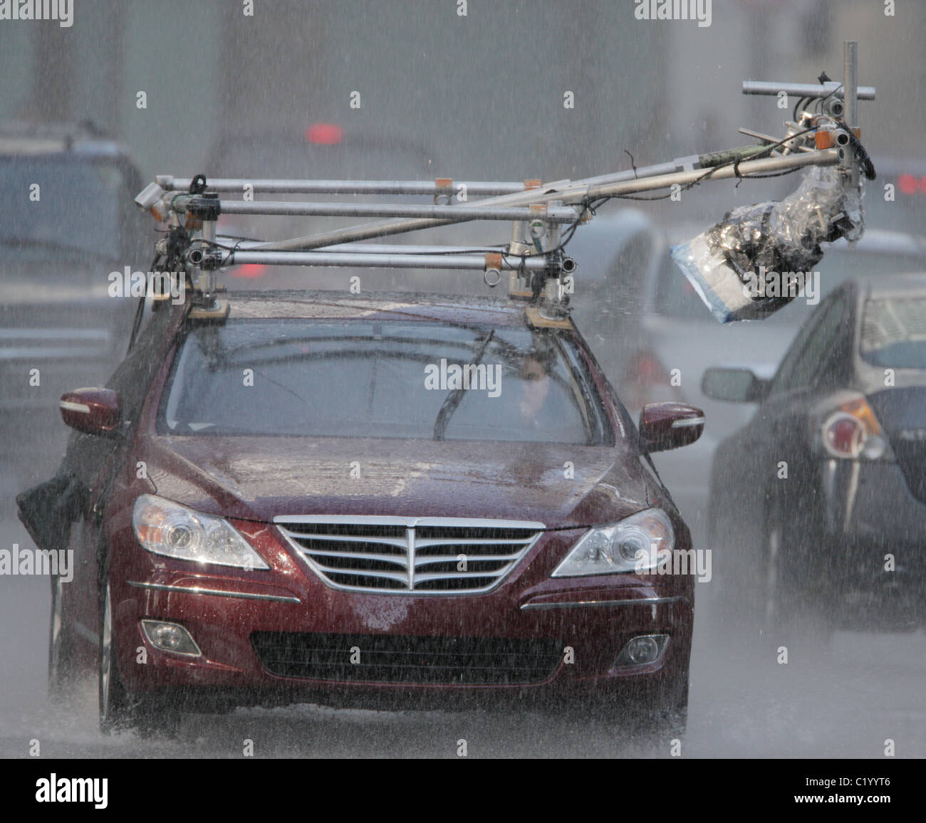 Leonardo DiCaprio driving a car in the rain while filming a scene for ...