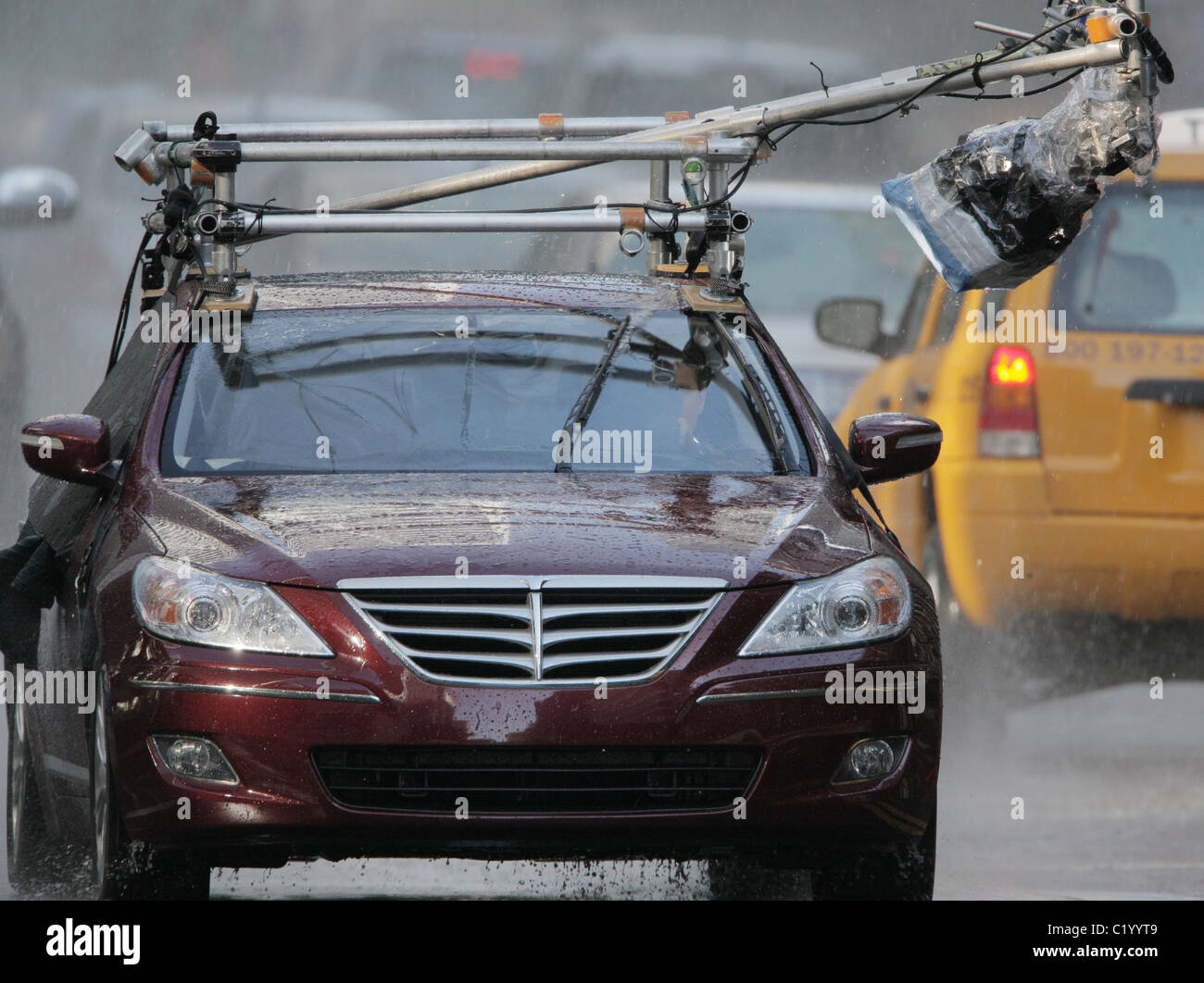Leonardo DiCaprio driving a car in the rain while filming a scene for ...