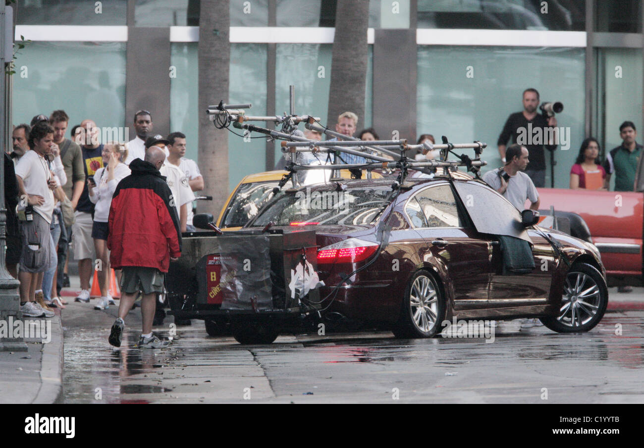 Leonardo DiCaprio driving a car in the rain while filming a scene for ...
