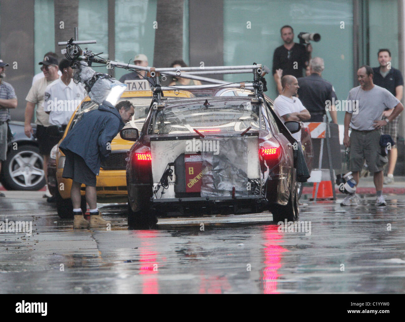 Leonardo DiCaprio driving a car in the rain while filming a scene for ...