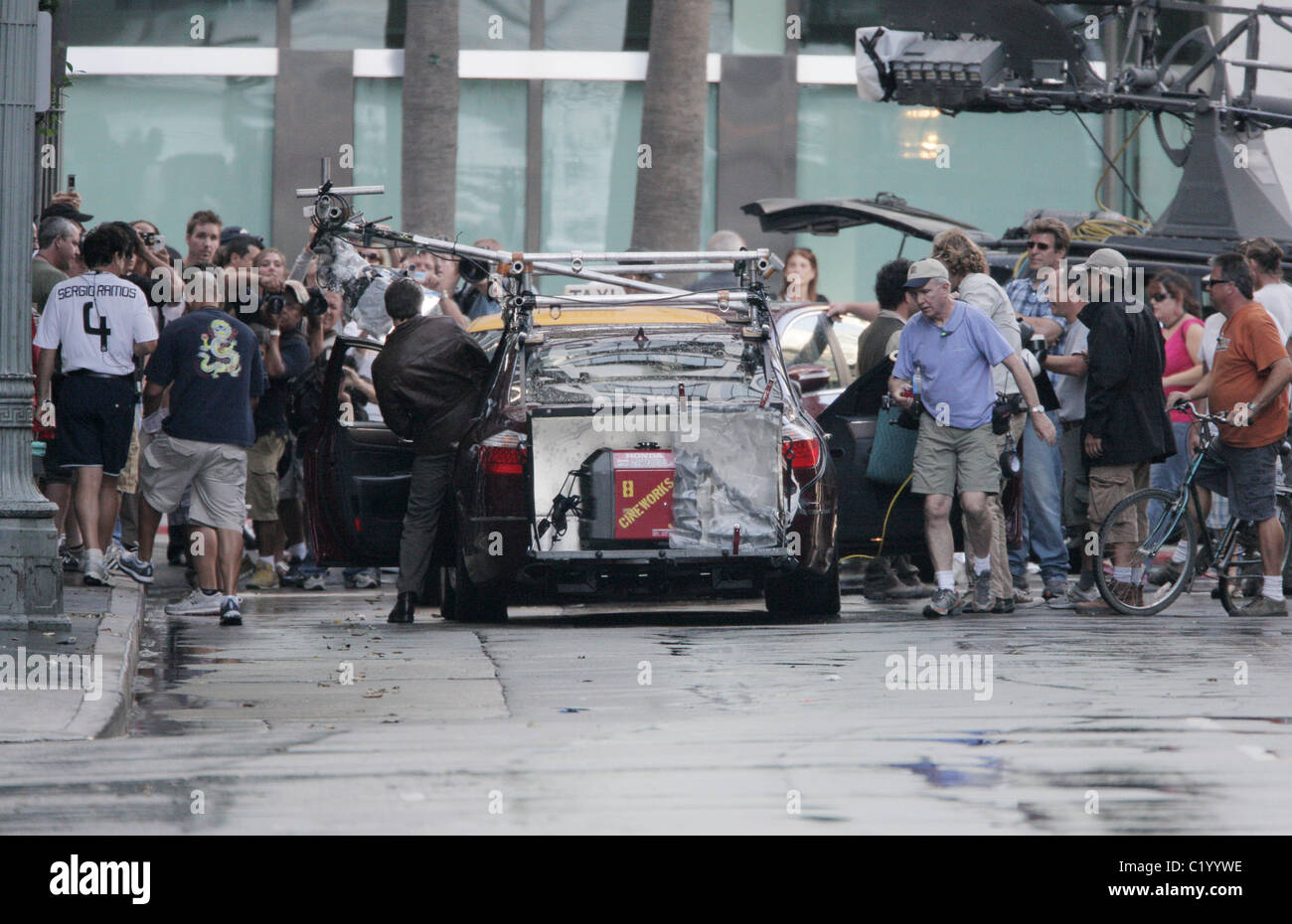 Leonardo DiCaprio driving a car in the rain while filming a scene for ...