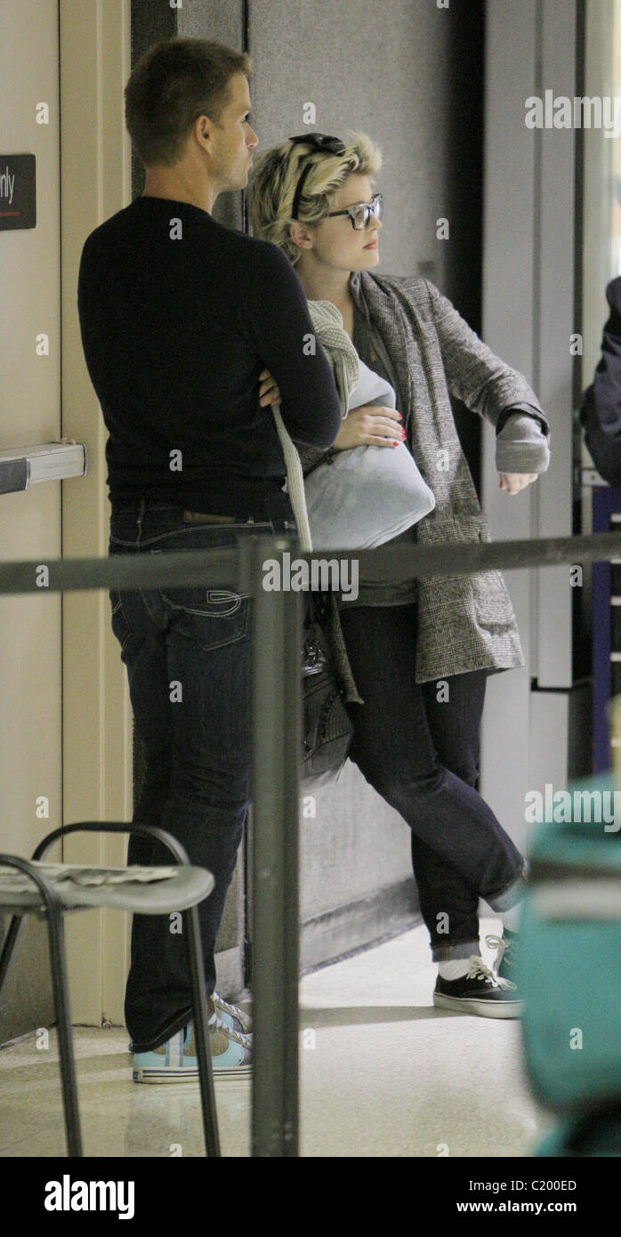 Kelly Osbourne carrying a travel pillow as she arrives at LAX airport ...