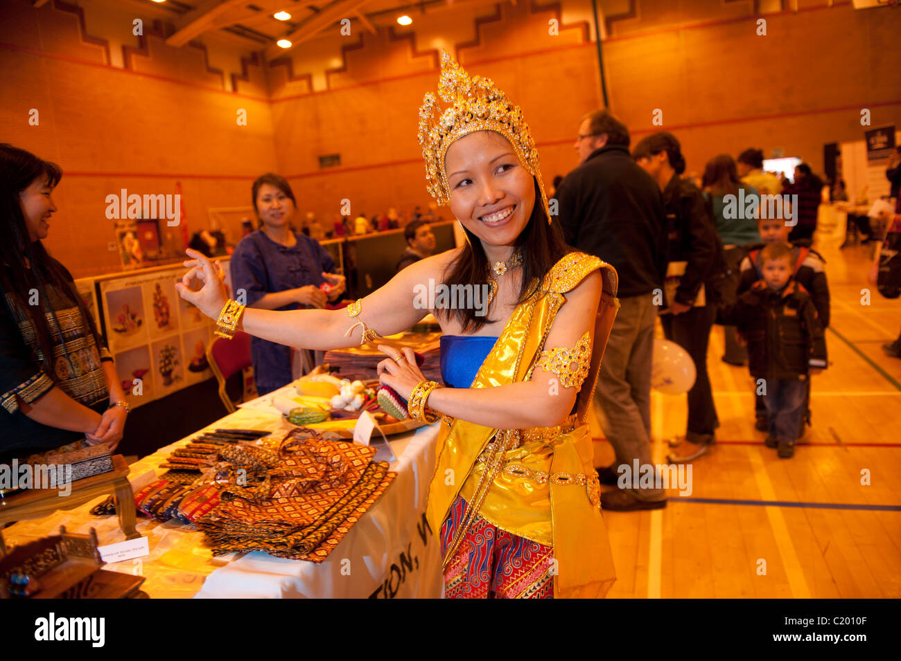 A smiling woman Thai dancing at a multicultural awareness event ...