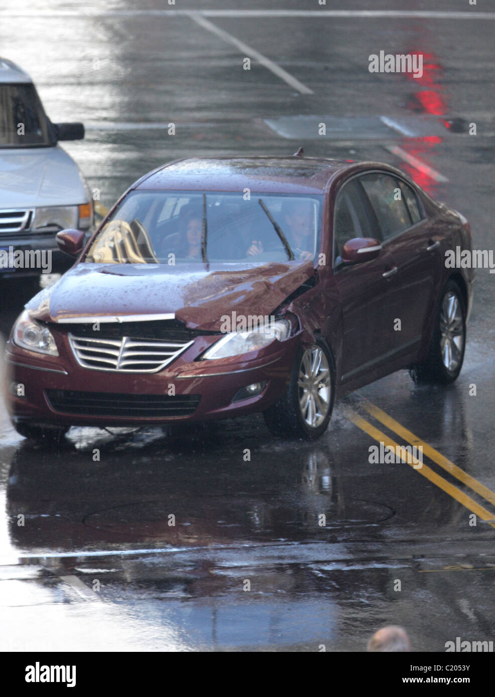 Actors stage a gun fight in the rain filming a scene for 'Inception ...