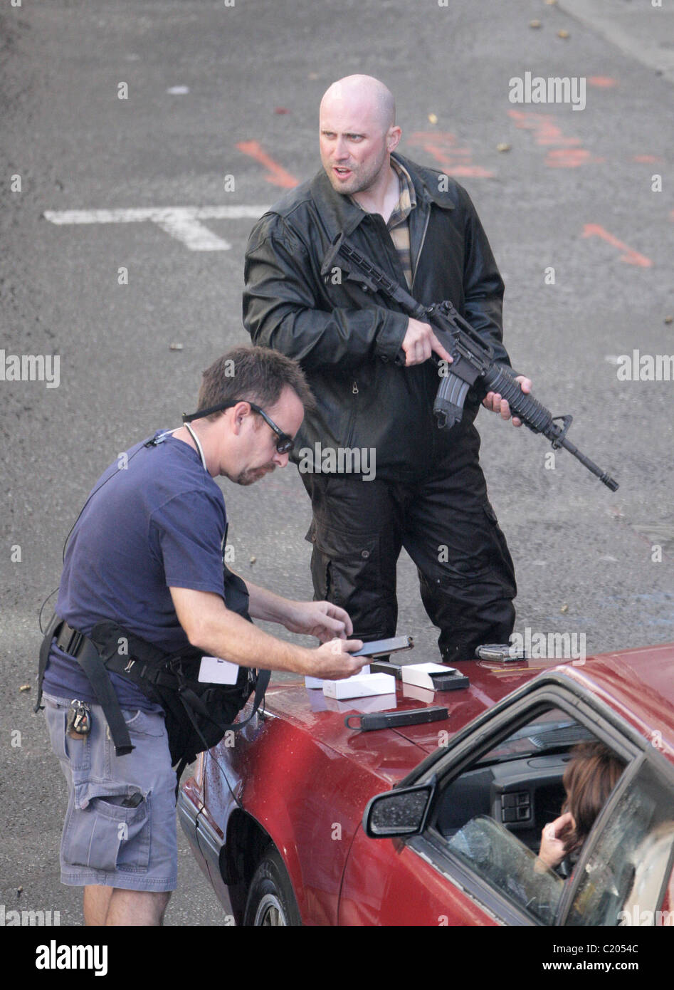 Actors stage a gun fight in the rain filming a scene for 'Inception ...