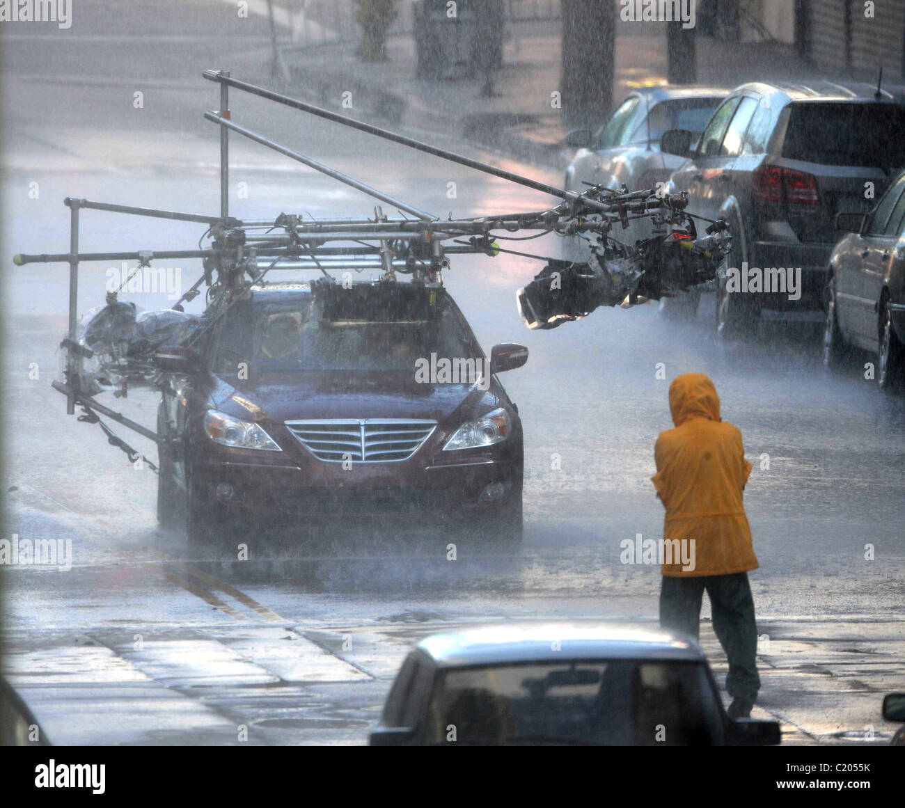Actors stage a gun fight in the rain filming a scene for 'Inception ...
